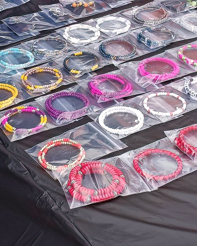 A rainbow of handcrafted bracelets lined up like edible treats. These wearable treasures showcase the artisanal spirit thriving in Durham's marketplace.
