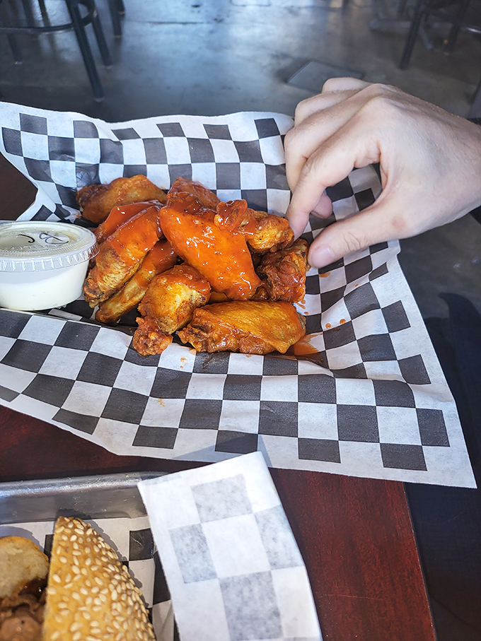 Buffalo wings glowing with that unmistakable orange hue – nature's way of saying "I'm delicious but I will absolutely stain your favorite shirt."