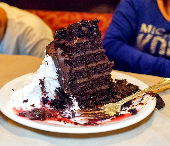 This towering chocolate cake isn't just dessert – it's an architectural achievement of cocoa engineering that demands to be photographed before demolished.