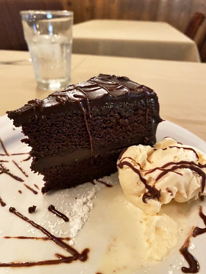 A chocolate cake so rich it probably has its own accountant. That ice cream isn't melting—it's swooning in chocolate's presence.