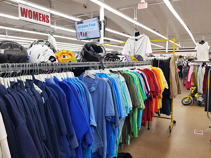 The rainbow of possibilities in the women's section – where color-coordinated clothing creates a visual feast for fashion-forward thrifters.