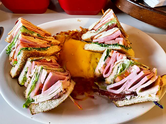 Triple-stacked club sandwich perfection that makes you wonder why anyone settles for ordinary lunch options.