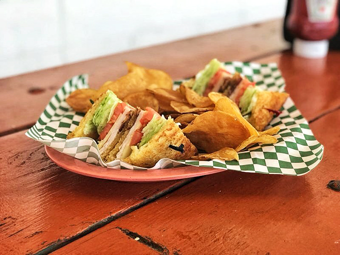 A club sandwich built like a skyscraper of flavor—the architectural marvel of lunch options that requires strategic first bites.