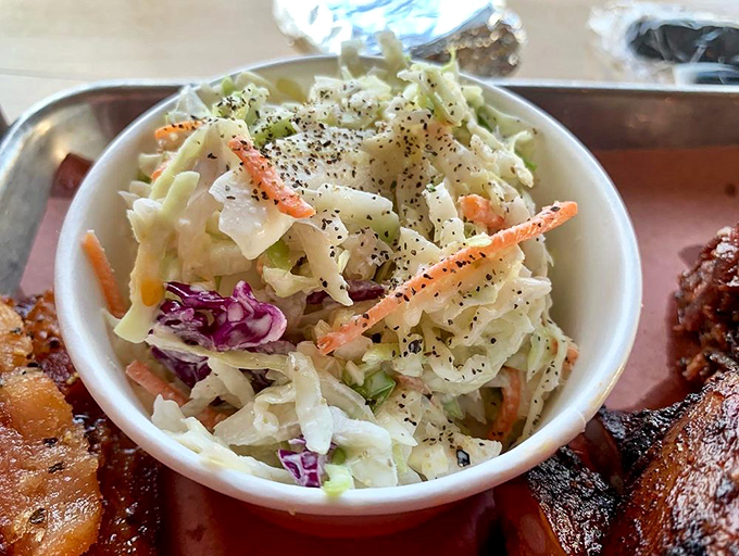 Coleslaw that knows its role – not just a side dish but a crucial counterpoint to the smoky richness, like a palate-cleansing best friend.