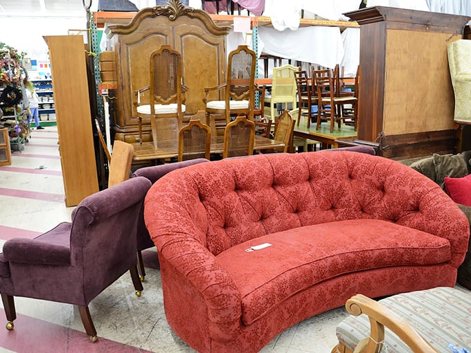 The coral loveseat demands attention like a Broadway diva – paired with that purple chair, it's the 1980s living room ensemble of your wildest dreams.