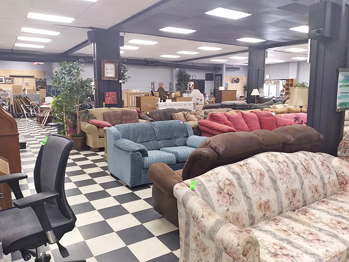 Couch paradise on a classic checkerboard floor—where your next conversation piece sits waiting, possibly beneath that floral pattern you swore you'd never love.