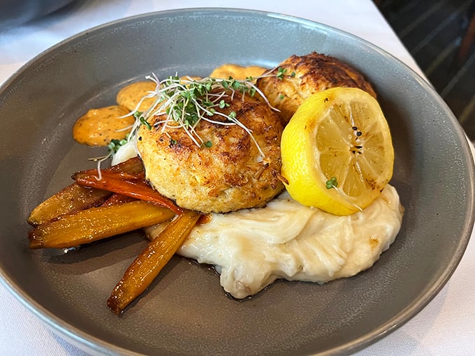 The star of the show—Riverwalk's famous crab cake—perched atop creamy mashed potatoes with roasted carrots standing by like tasty bodyguards.