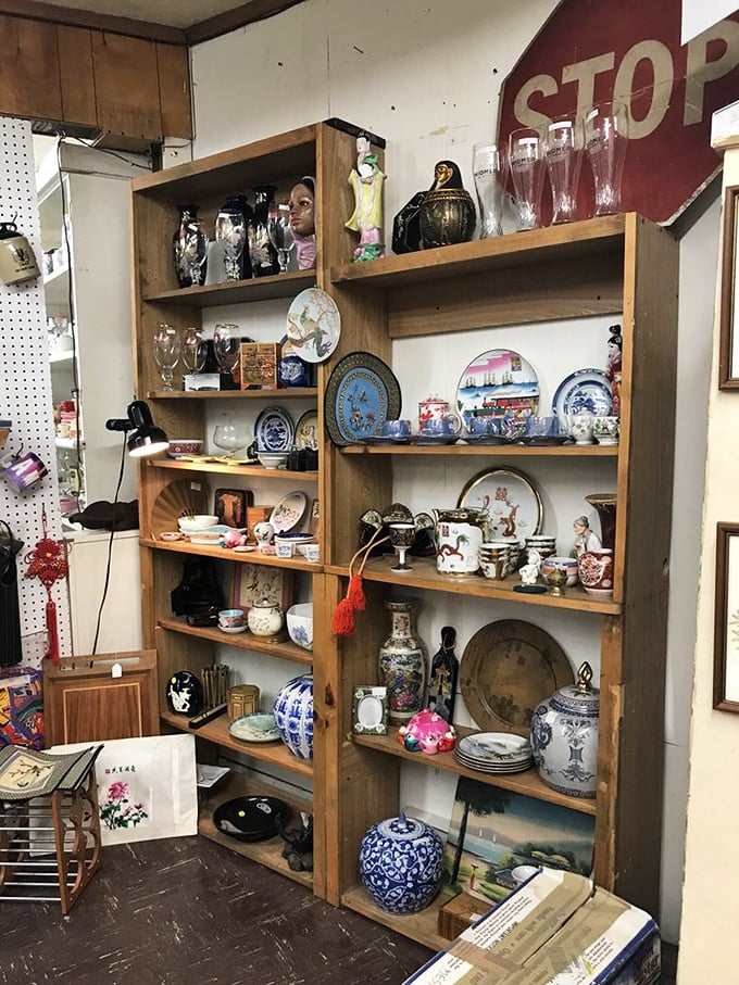 China, collectibles, and curiosities line these wooden shelves, each piece whispering tales of dinner parties and special occasions from decades past.