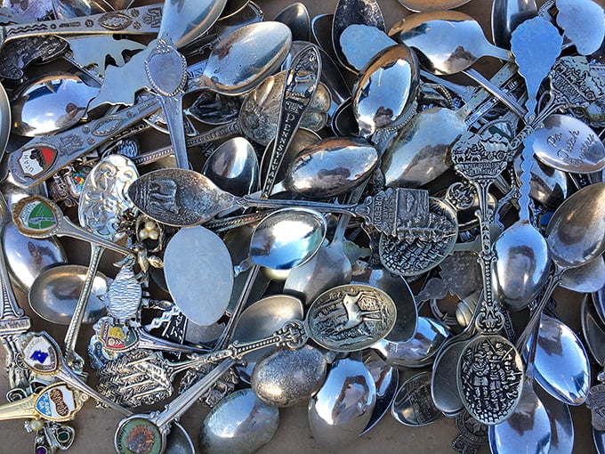 Souvenir spoons gleam in the sunlight, each one a metallic postcard from someone's past adventures across America.