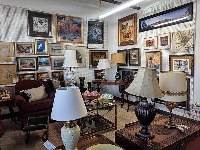 An art lover's paradise where framed landscapes and vintage lamps create a gallery atmosphere that's part museum, part living room inspiration.