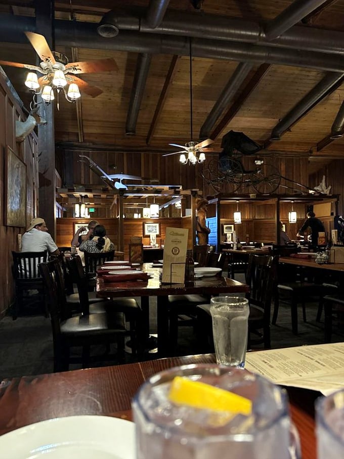 The dining room balances rustic charm with comfortable seating, where Western artifacts hang from wooden beams like memories from California's ranching past.