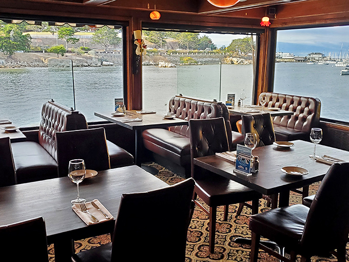 Those leather booths and panoramic bay views aren't just seating—they're front-row tickets to nature's aquatic theater, with dinner service included.