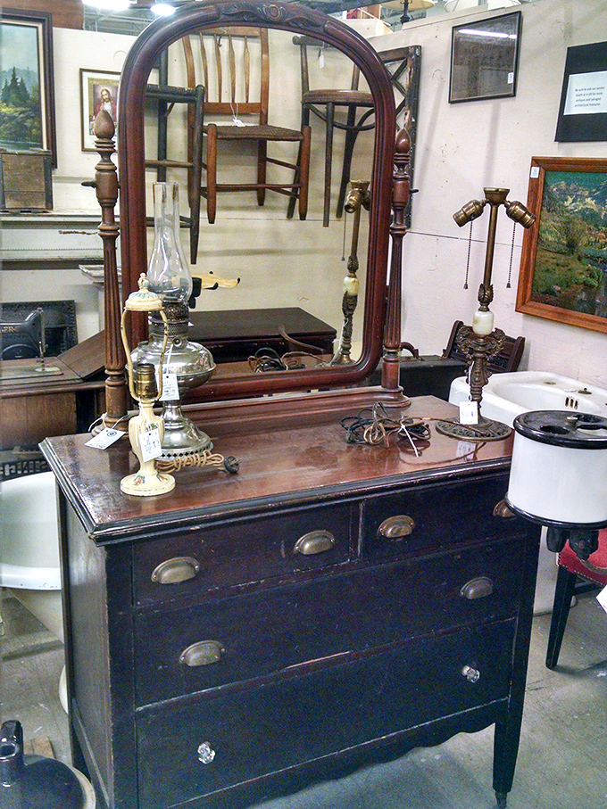 This antique dresser with beveled mirror has witnessed a century of morning routines—imagine the faces it's reflected since the early 1900s.