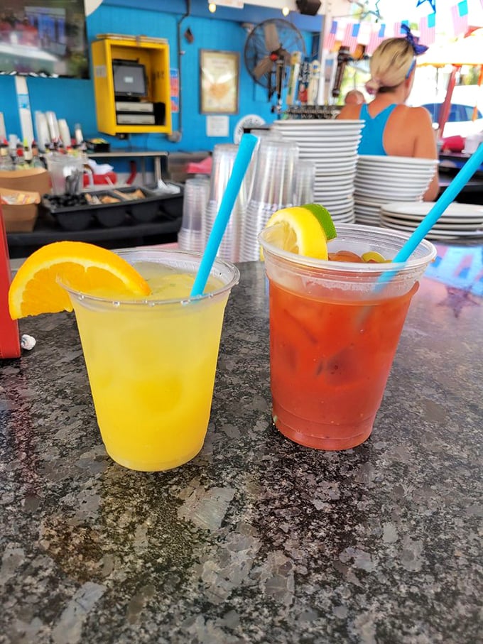 Tropical drinks in plastic cups—because nothing says "I'm on vacation" quite like fruit juice, rum, and a straw, even if you're just on lunch break.
