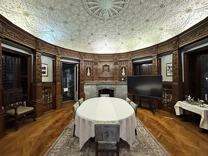 The formal dining room's elaborate ceiling and wood paneling create the perfect setting for dinners that definitely weren't served on paper plates.