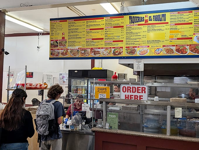 The ordering counter – where dreams become reality and indecision becomes your greatest enemy as hungry patrons contemplate their burrito destiny.