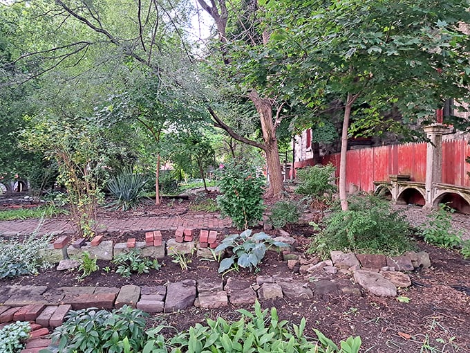 This garden's brick pathways and wild greenery create a secret sanctuary where you half expect to find a talking rabbit checking his pocket watch.