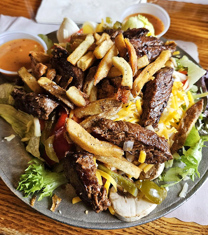 This grilled sirloin salad doesn't know it's supposed to be health food. Perfectly seared beef, golden fries, and fresh greens create a magnificent contradiction.