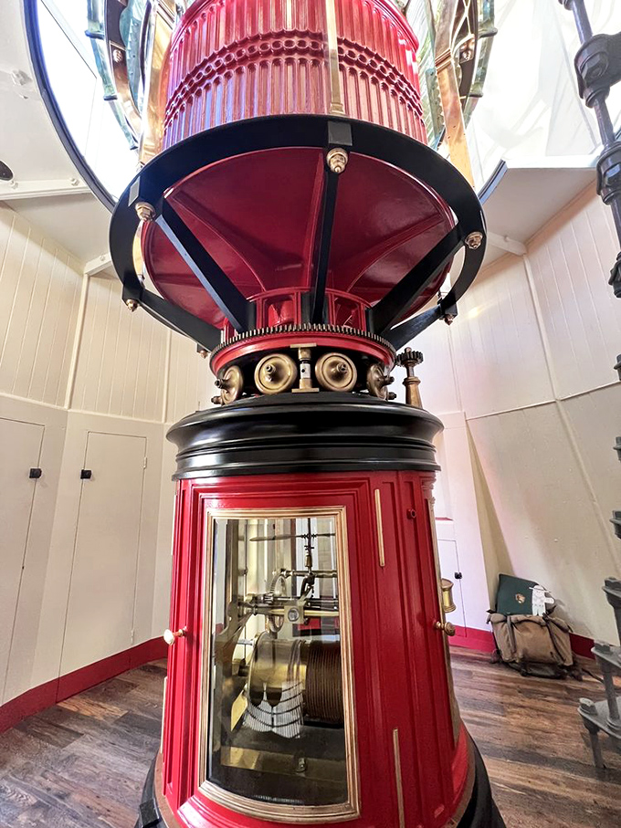 Engineering marvel meets art – the ruby-red Fresnel lens with its intricate prisms once projected light 24 miles out to sea.