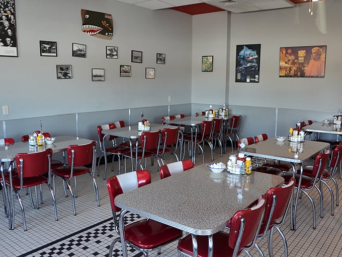Classic diner geometry: red chairs, silver tables, checkerboard floors. Einstein would approve of how perfectly these elements combine to create comfort.