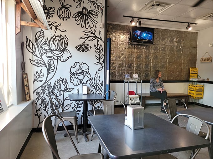 Modern industrial meets cozy café with floral wall art that makes waiting for your pierogi order feel like time well spent.