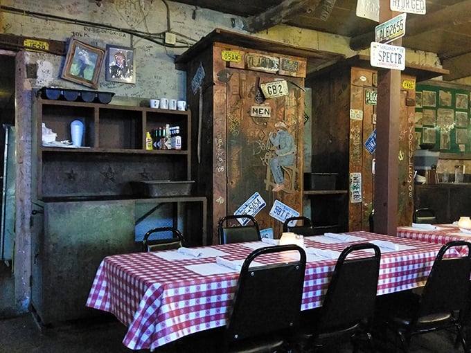 The men's room sign surrounded by license plates and graffiti tells you everything: this place embraces its character like an old friend who's earned the right to be eccentric.