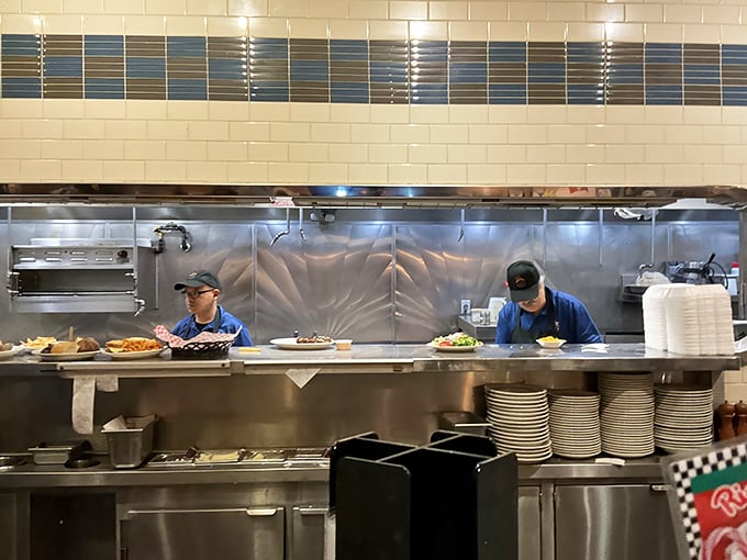 Where the magic happens—skilled cooks orchestrating a delicious symphony of sizzles and flips behind a gleaming stainless steel stage.