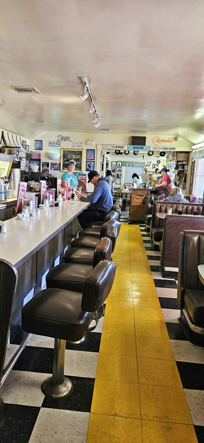 The classic diner counter—where strangers become friends over pie, and the yellow stripe leads you to happiness one stool at a time.