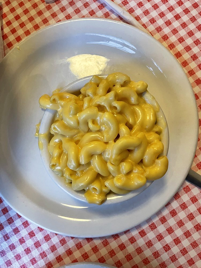 Mac and cheese that puts the boxed stuff to shame—a golden pool of creamy, cheesy goodness that's worth every delicious calorie.