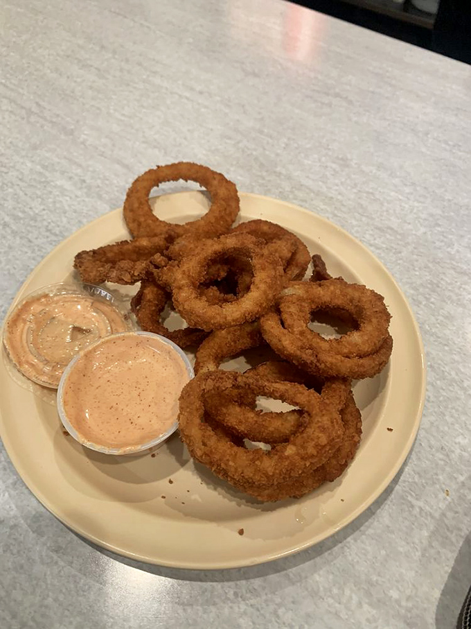 Onion rings with the perfect crunch-to-softness ratio—like edible jewelry that leaves your fingers happily greasy and your soul content.