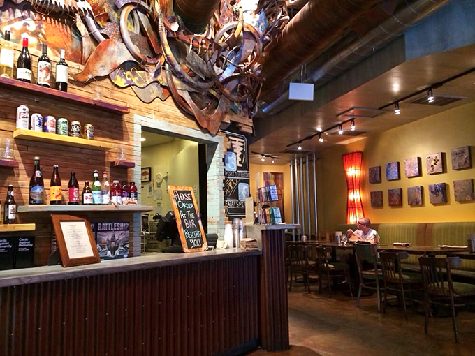 Wooden warmth meets artistic chaos – exposed pipes and colorful accents create a space that feels both carefully designed and spontaneously cool.