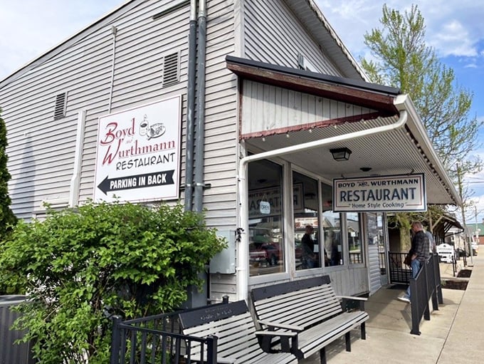 The exterior view shows a restaurant that doesn't need to shout about its authenticity—the wooden benches have been welcoming weary shoppers for decades.