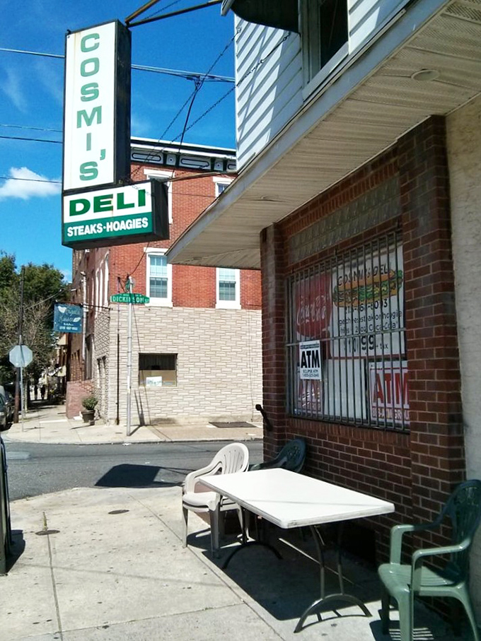 Sidewalk dining, Philadelphia-style. The plastic table and chair setup says "no pretension here"—just focus on the sandwich masterpiece in your hands.