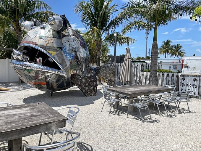 The outdoor dining area features a massive metal grouper sculpture—proof that "ugly" can indeed be spectacular art.