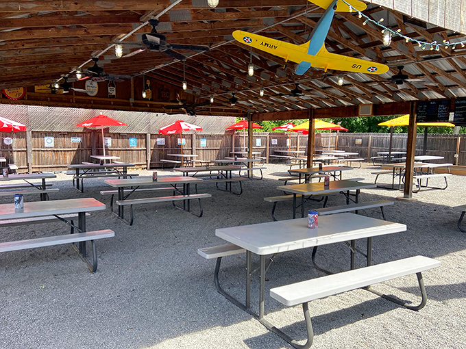 The outdoor dining area with its picnic tables and hanging model airplane creates that perfect "summer cookout" vibe, even if you're just visiting for lunch.