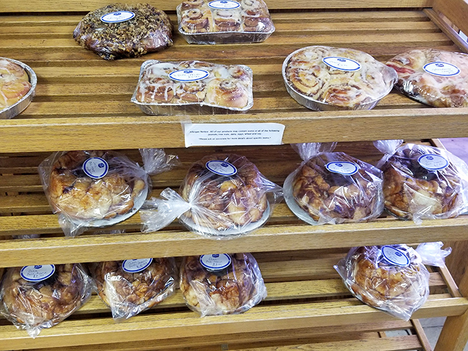 Packaged pastries lined up on wooden shelves – because sometimes you need to bring home reinforcements for later sugar emergencies.