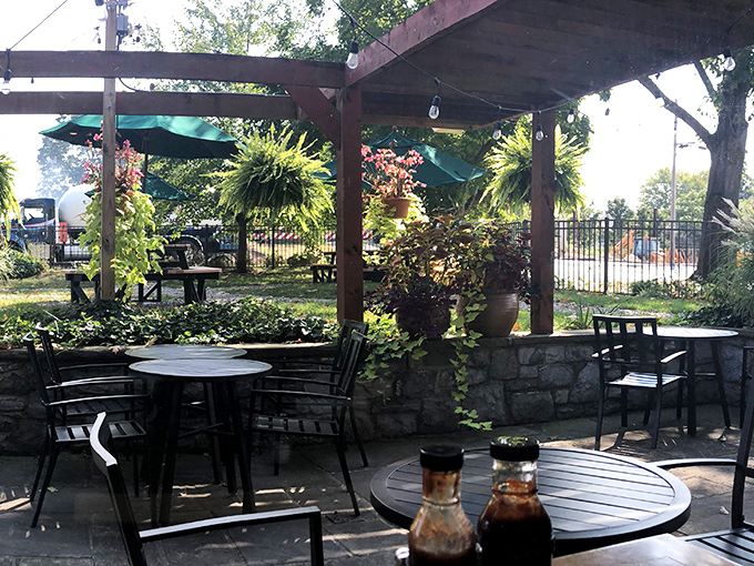 The outdoor patio where summer breezes carry the scent of smoke and spice, nature's perfect dining companion.