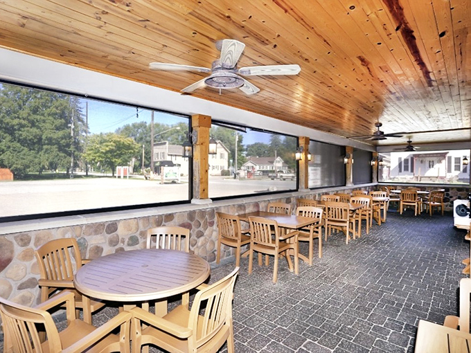 The screened patio offers a bright, airy alternative dining space. Those wooden chairs say "stay awhile"—and with food this good, why wouldn't you?