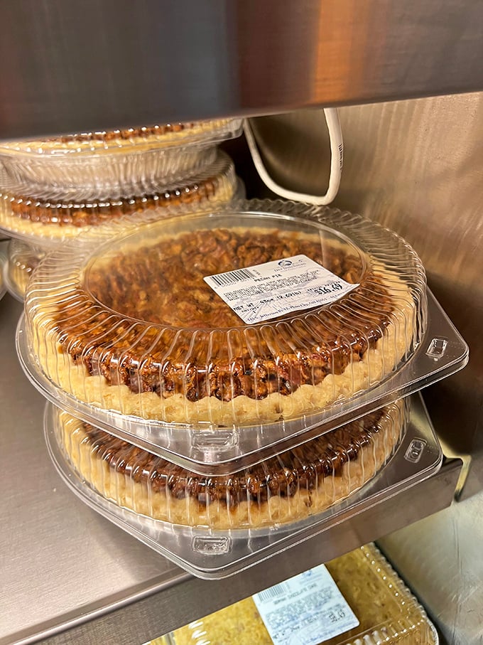 Pecan pies stacked and ready for adoption. These aren't just desserts—they're the reason people invented the phrase "I shouldn't, but I will."