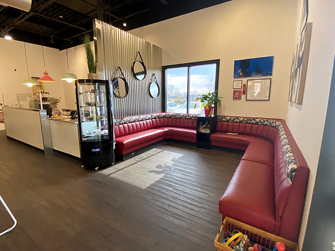 The curved red banquette isn't just seating—it's a front-row ticket to the breakfast show. Comfort never looked so stylish.