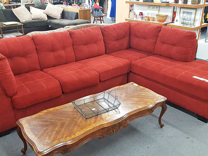 This bold red sectional makes a statement without saying a word. Paired with an antique coffee table, it's the perfect example of thrift store magic in action.