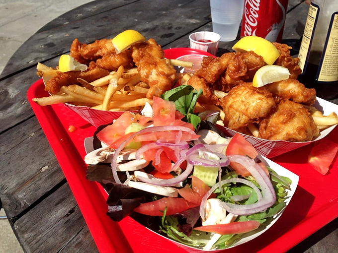 A fresh salad offering a crisp counterpoint to fried delights—like bringing a responsible friend to balance out your more indulgent companions.