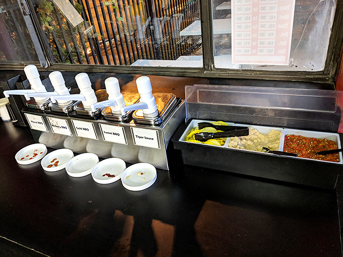 The condiment station – where tiger sauce, barbecue sauce, and other flavor enhancers stand ready to customize your meat masterpiece to personal perfection.