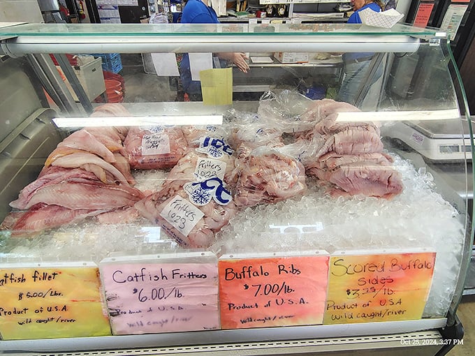 Behind the glass lies treasure more valuable than gold: fresh catfish, buffalo, and other river delicacies awaiting their transformation into crispy perfection.