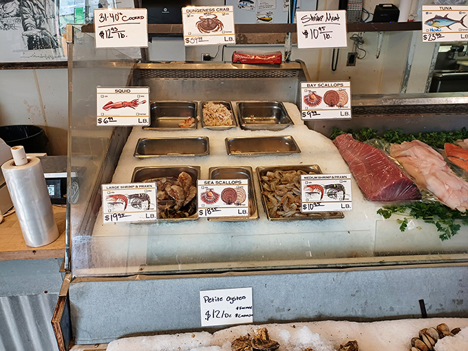 The seafood display case – where the day's catch waits patiently, making eye contact and silently suggesting, "Pick me, I'm the freshest one here."