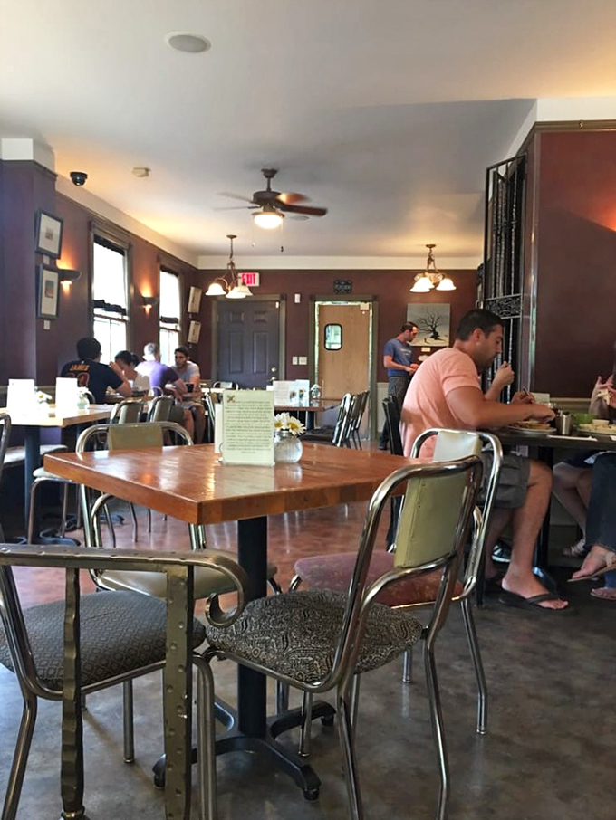 The dining room buzzes with that perfect café energy—warm lighting, wooden tables, and the collective happiness of people about to enjoy something delicious.