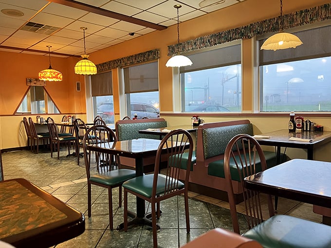 Stained glass pendant lights cast a warm glow over teal booths—the classic diner setting where memories are made between coffee refills.