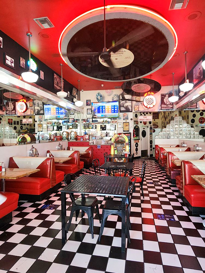 The diner's interior is a masterclass in nostalgic design. Vinyl booths, record décor, and checkered floors create a symphony of mid-century magic.