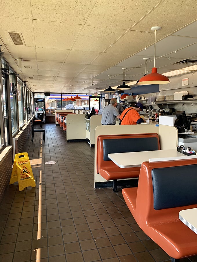 Sunlight streams across orange booths that have cradled countless conversations, confessions, and "just one more coffee" morning decisions.