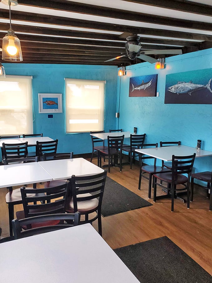 Dining room simplicity that says, "We put our effort into the food, not fancy chandeliers." Those fish on the wall aren't just decoration—they're inspiration.